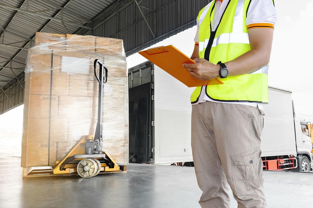 Image shows person recording consignment details