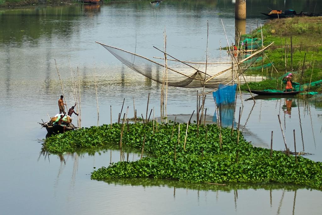 Image shows Indian fisherman on lake